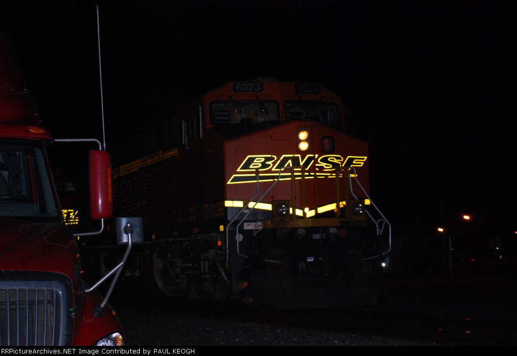 BNSF 6023 rear DPU behind BNSF 6043 rolls north throught this cold Nebraska town with an empty ...